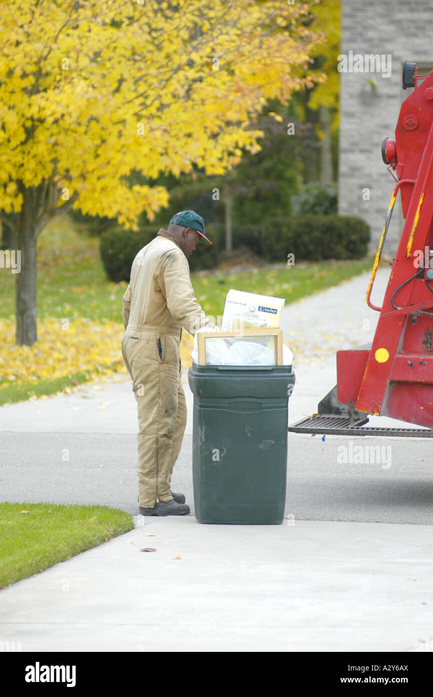 Residential trash collectors remove waste in a residential neighborhood ...