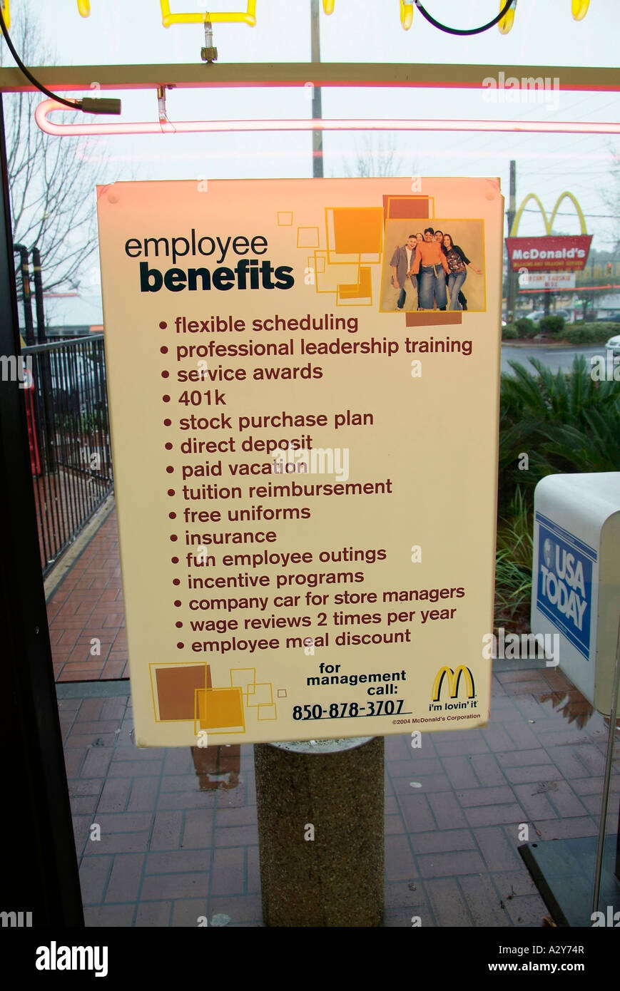 Help wanted sign with benefits listed at a fast food restaurant Stock ...