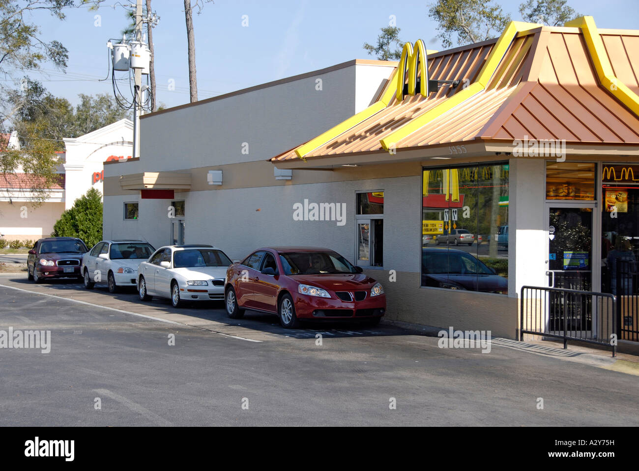 Cars Use A Drive Through Window To Order And Pick Up Fast Food At A