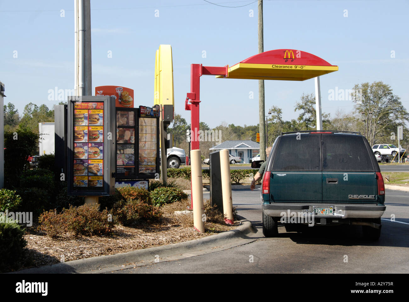Cars Use A Drive Through Window To Order And Pick Up Fast Food At A