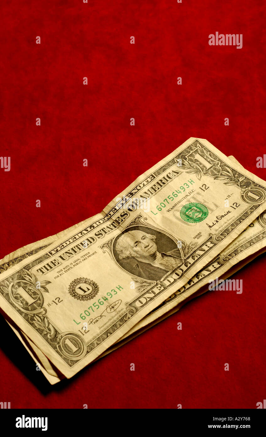 Color image of a stack of 1 one dollar US bills on a red background ...