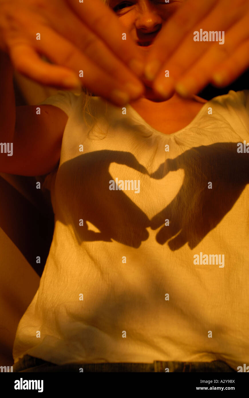 Hands form a heart on chest Stock Photo - Alamy