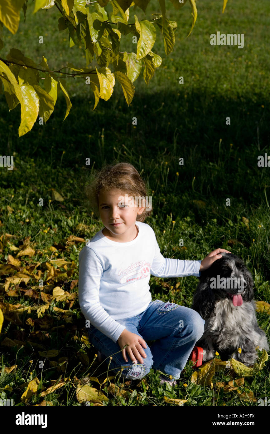 Pretty child with her cocker spaniel at the park Stock Photo - Alamy