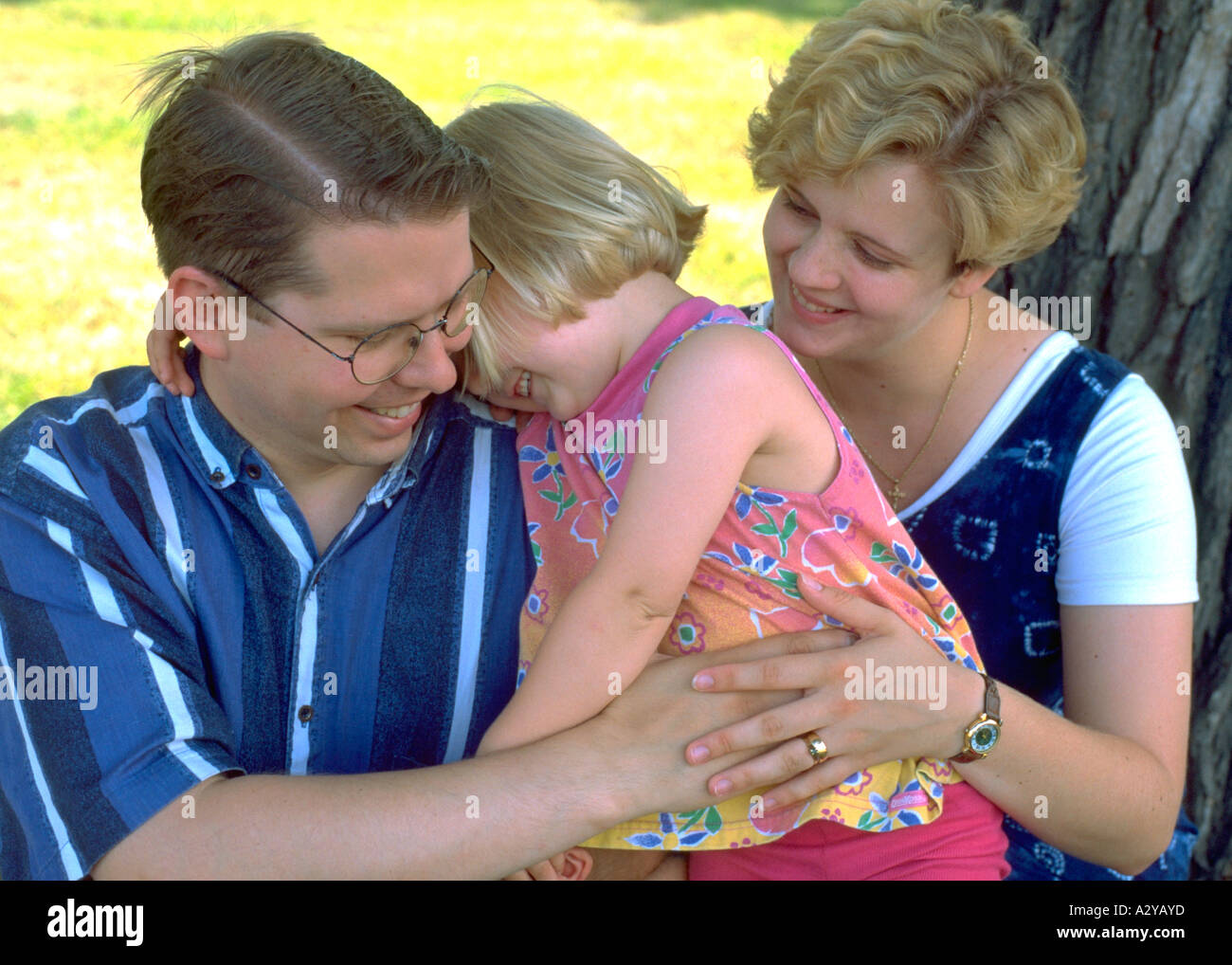 Mom and dad holding daughter age 30 and 4 at Merriam Park. St Paul ...