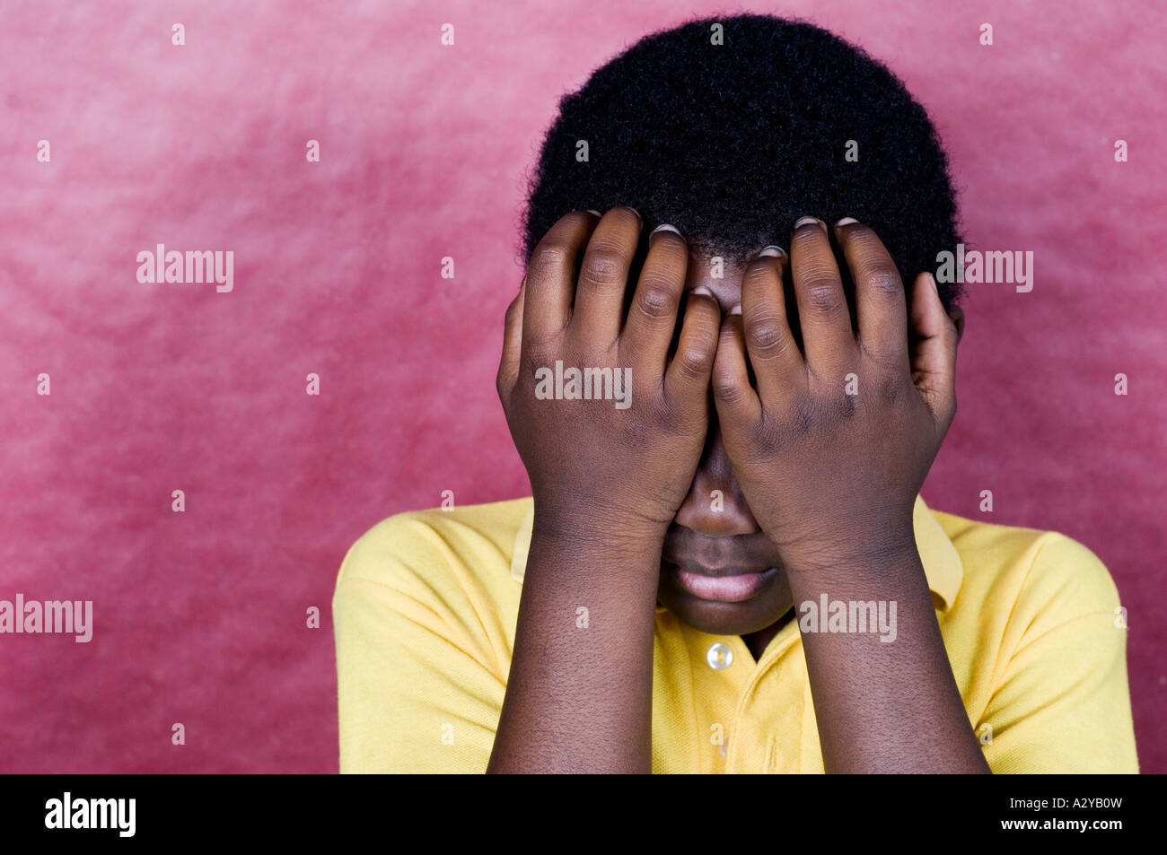 Scared boy hands covering face Stock Photo - Alamy
