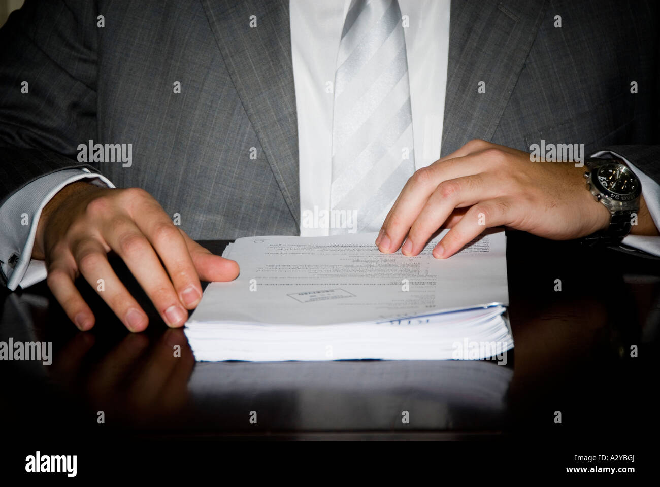 Businessman reviewing report Stock Photo - Alamy