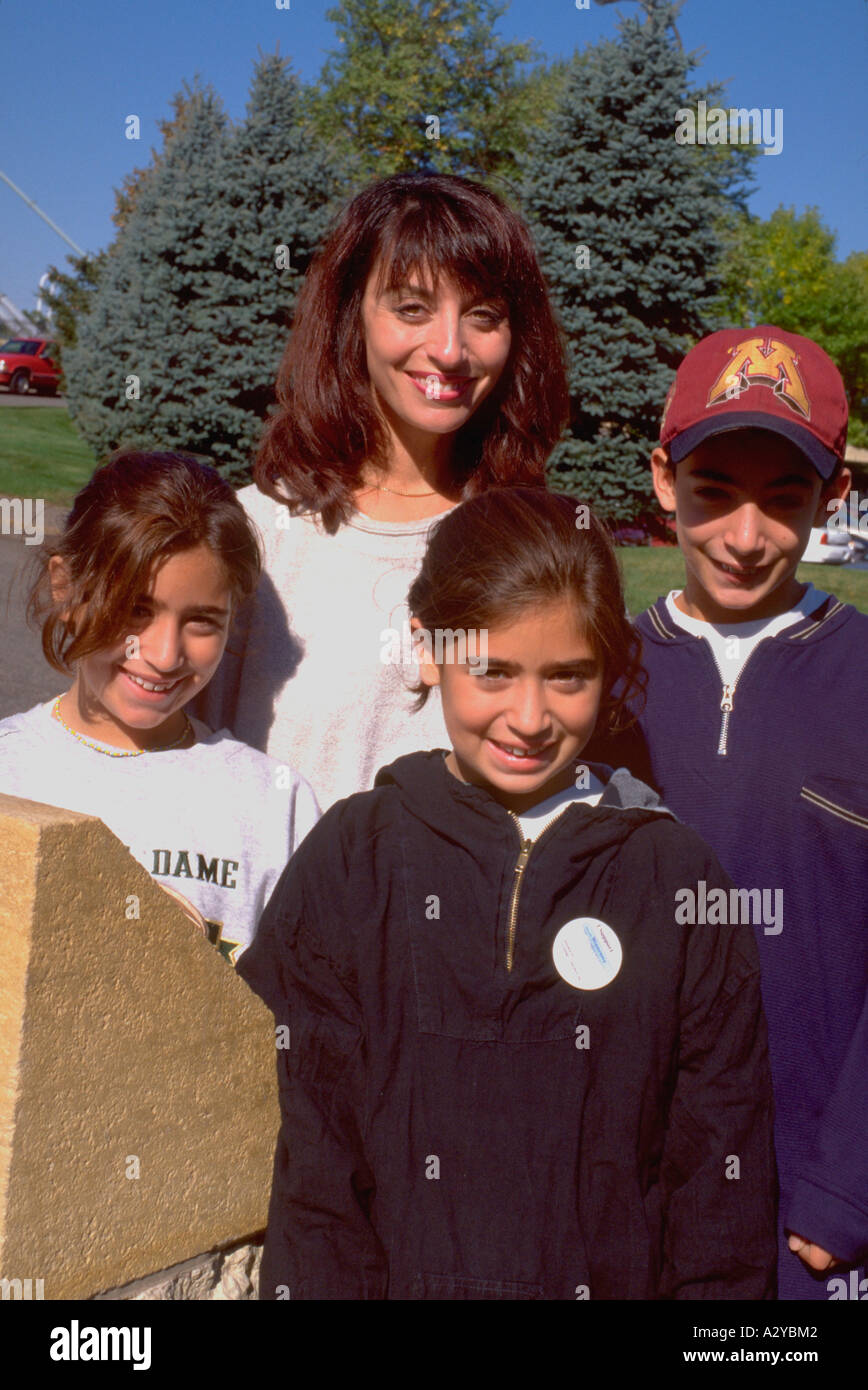 Mom age 32 with her three kids age 10 through 7 at city walk. Exchange ...