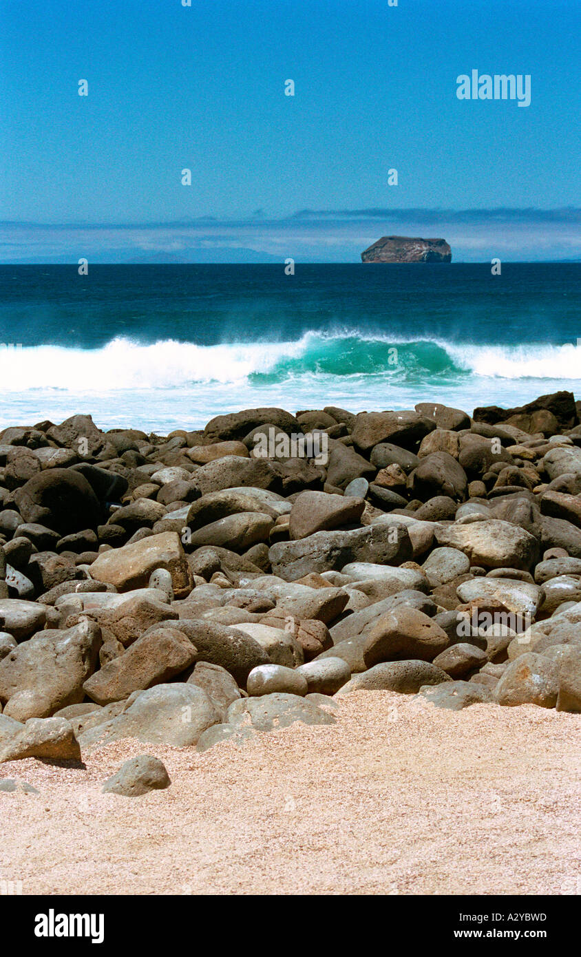 Beach scene, rocks, breaking waves and distant island, Galapagos Stock ...