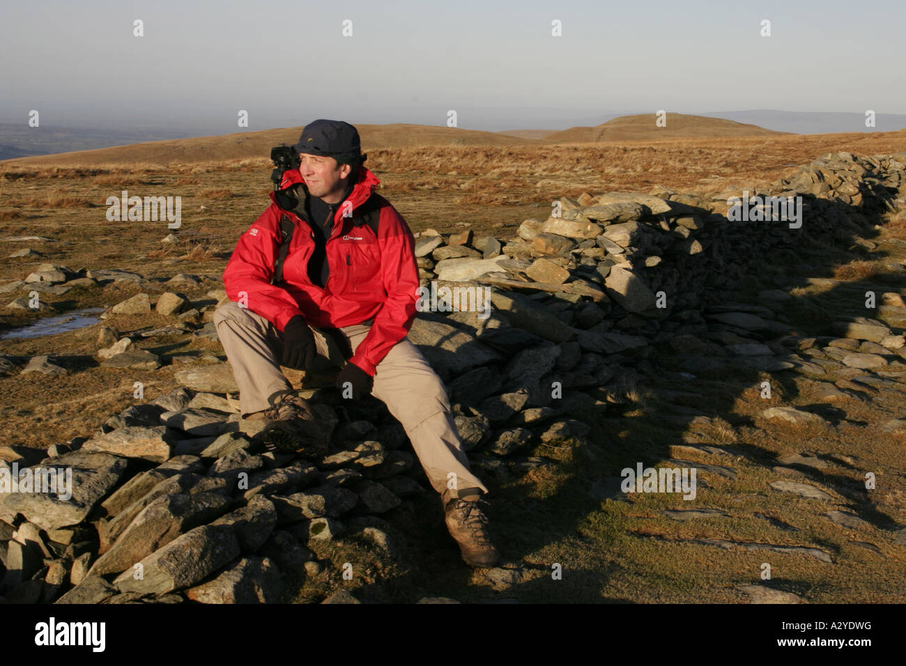 A walker resting on the summit of High Street Stock Photo - Alamy