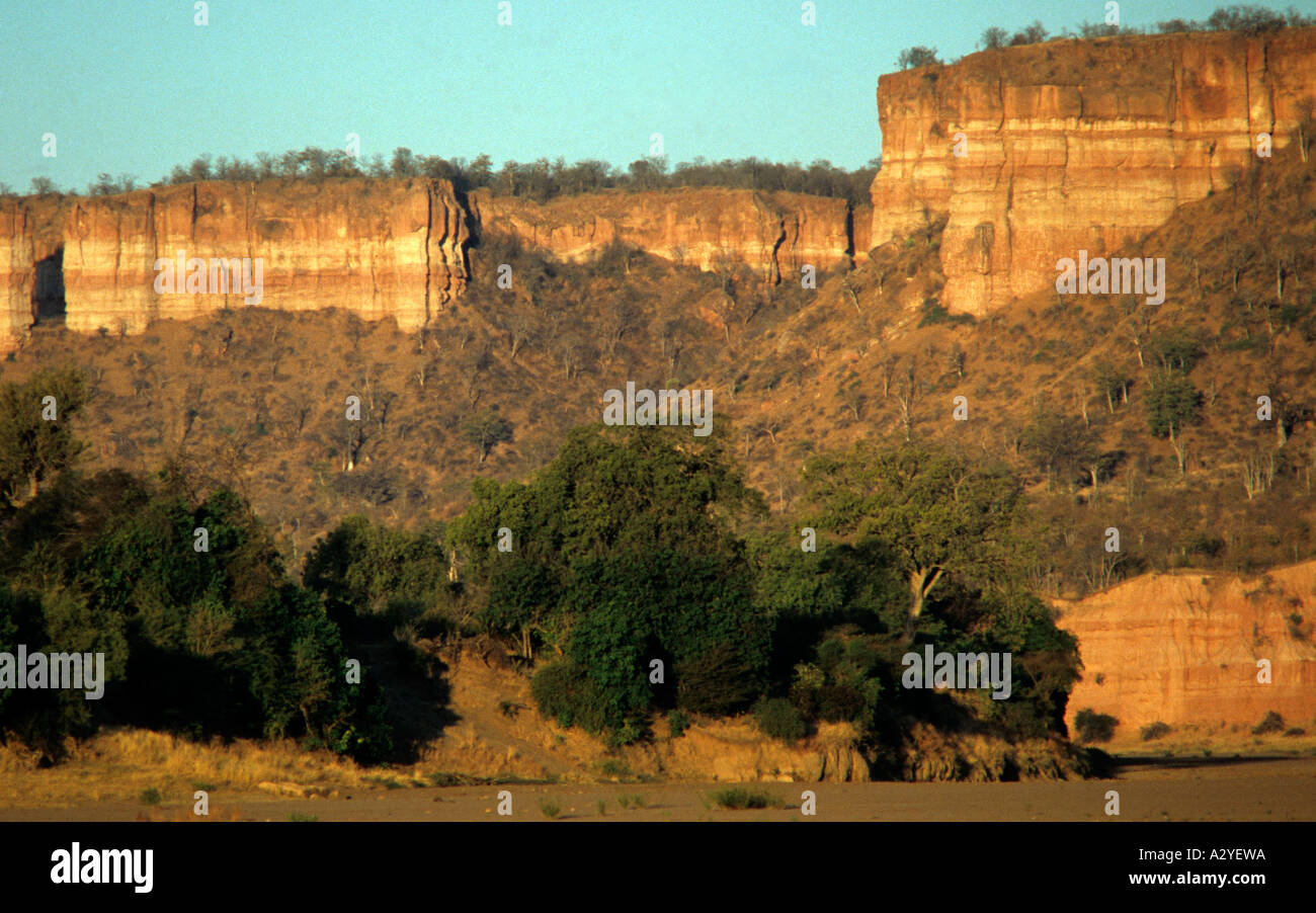 Dry riverbed with sandstone cliffs in the distance Gonarezhou National ...