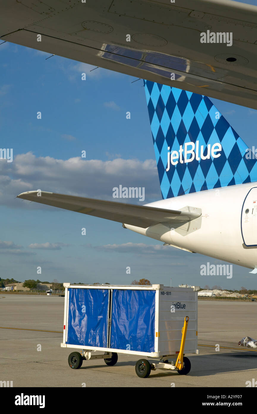 Underside of wing and tail of Jetblue passenger jet airplane with ...