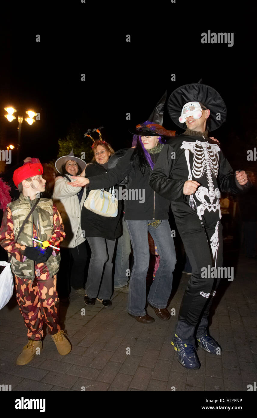 people in fancy dress do the conga dance through the crowd in guildhall ...