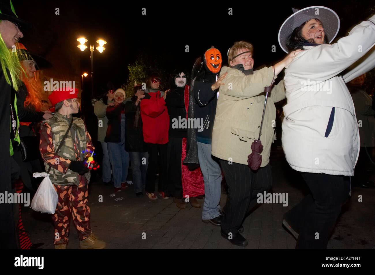 people in fancy dress do the conga dance through the crowd in guildhall ...