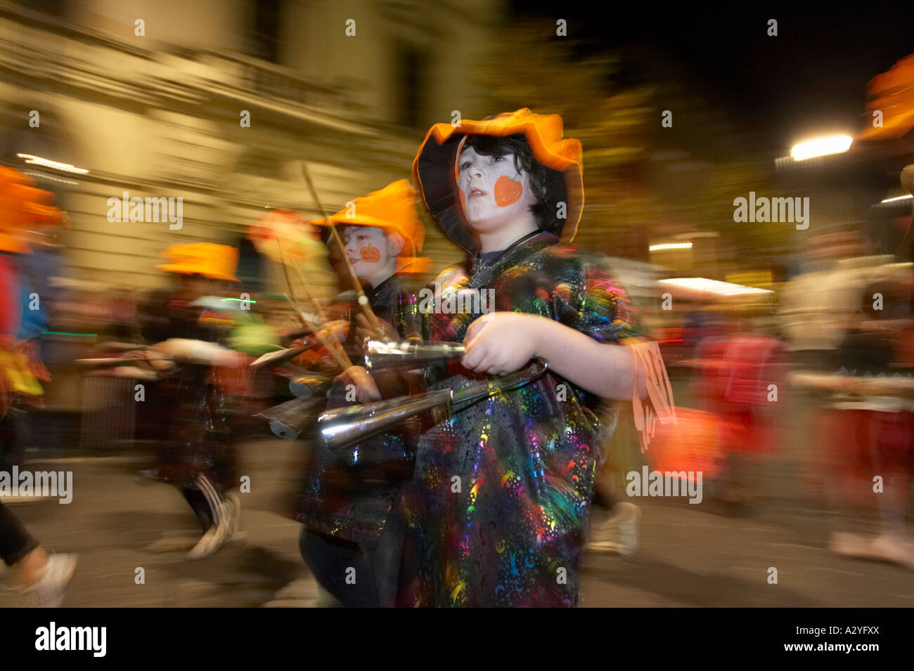 colourfully dressed children play instruments in parade down shipquay ...