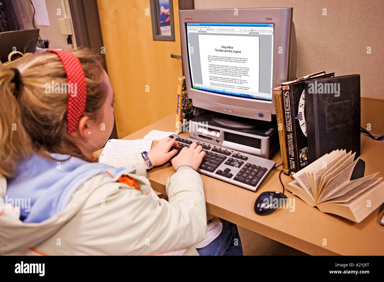 Image of a teenage girl using a computer to write a report on King ...