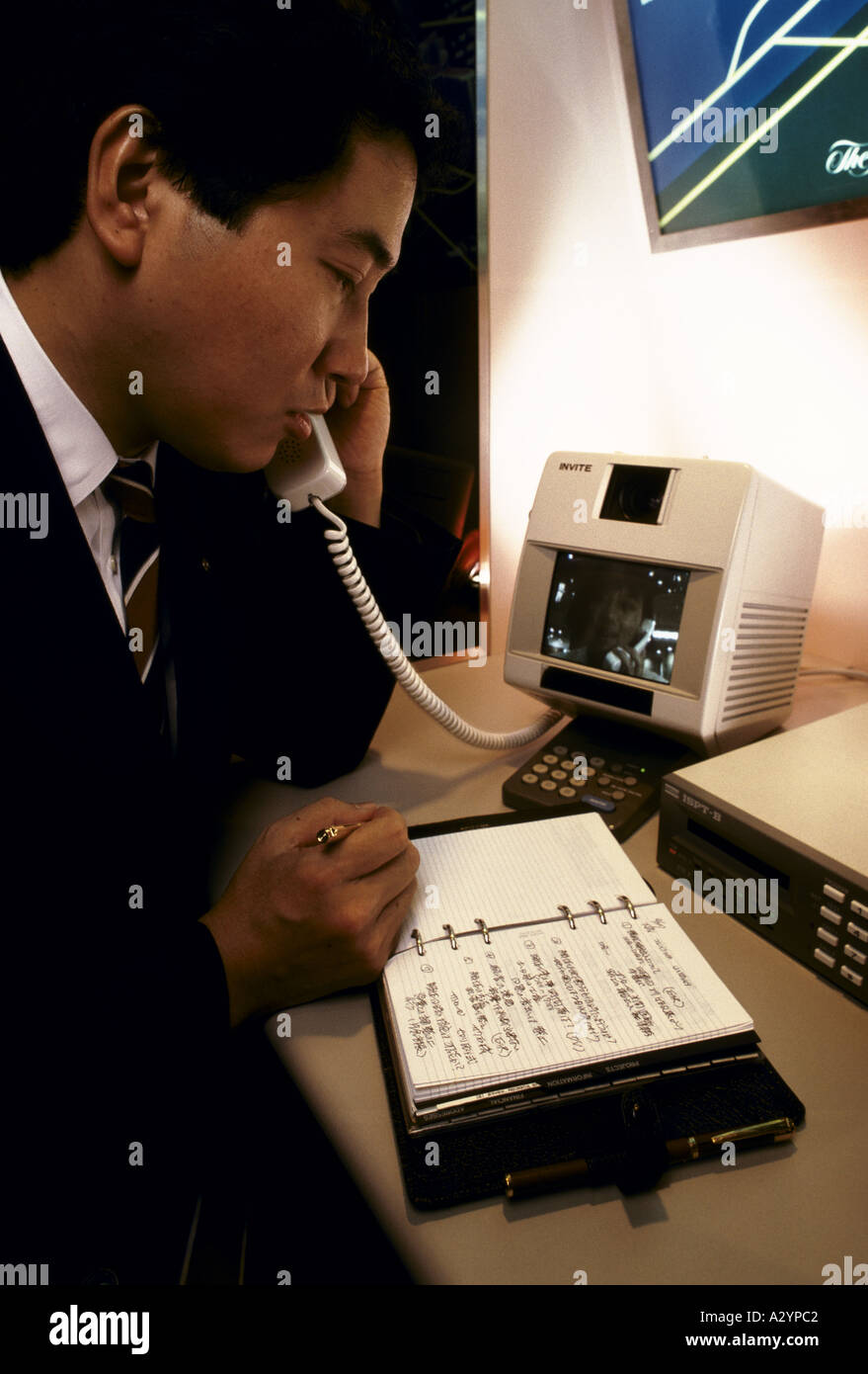man using telephone with monitor built in japan Stock Photo - Alamy