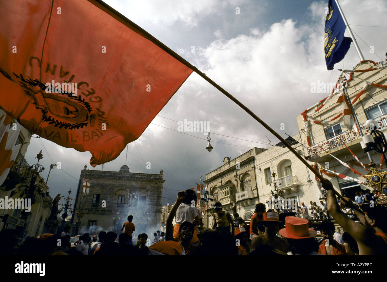 malta man waving large red flag above the heads of the crowd during the ...
