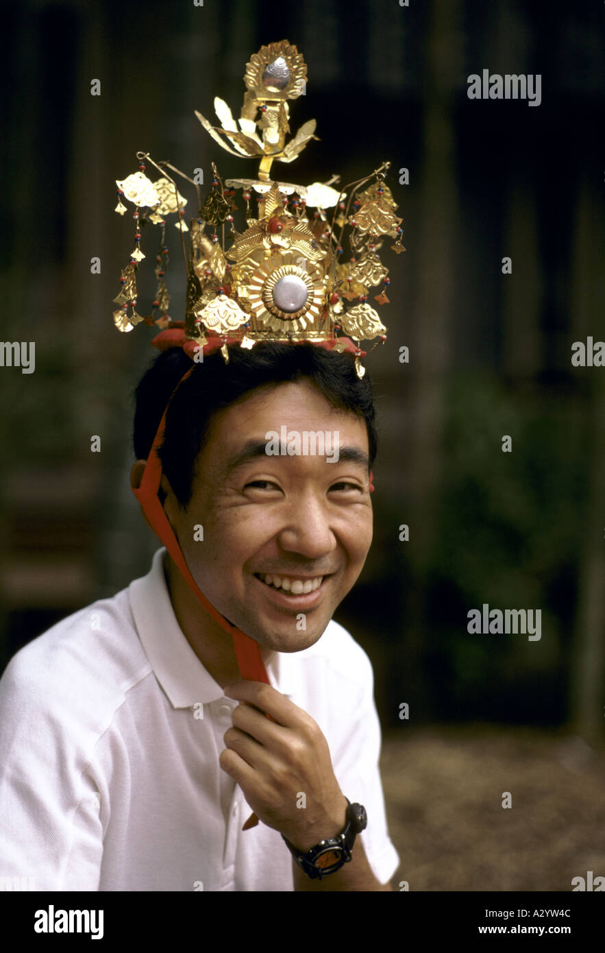 tokyo japan smiling japanese man wearing gold head dress 1987 Stock ...