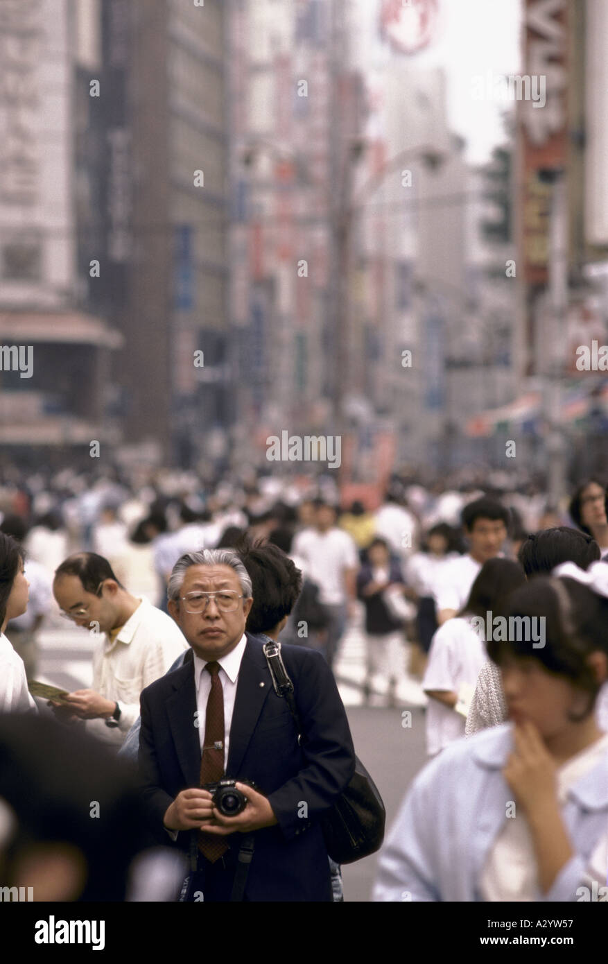 japanese man in tokyo street holding his camera Stock Photo - Alamy