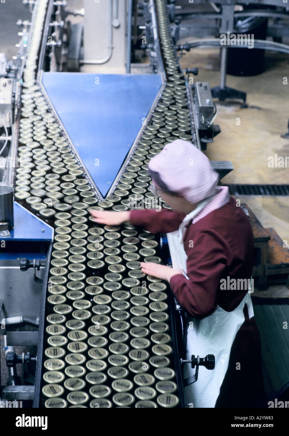 working on conveyor belt at chivers jam factory Stock Photo - Alamy