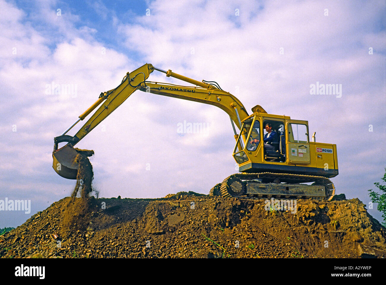 Digger on mound Stock Photo - Alamy