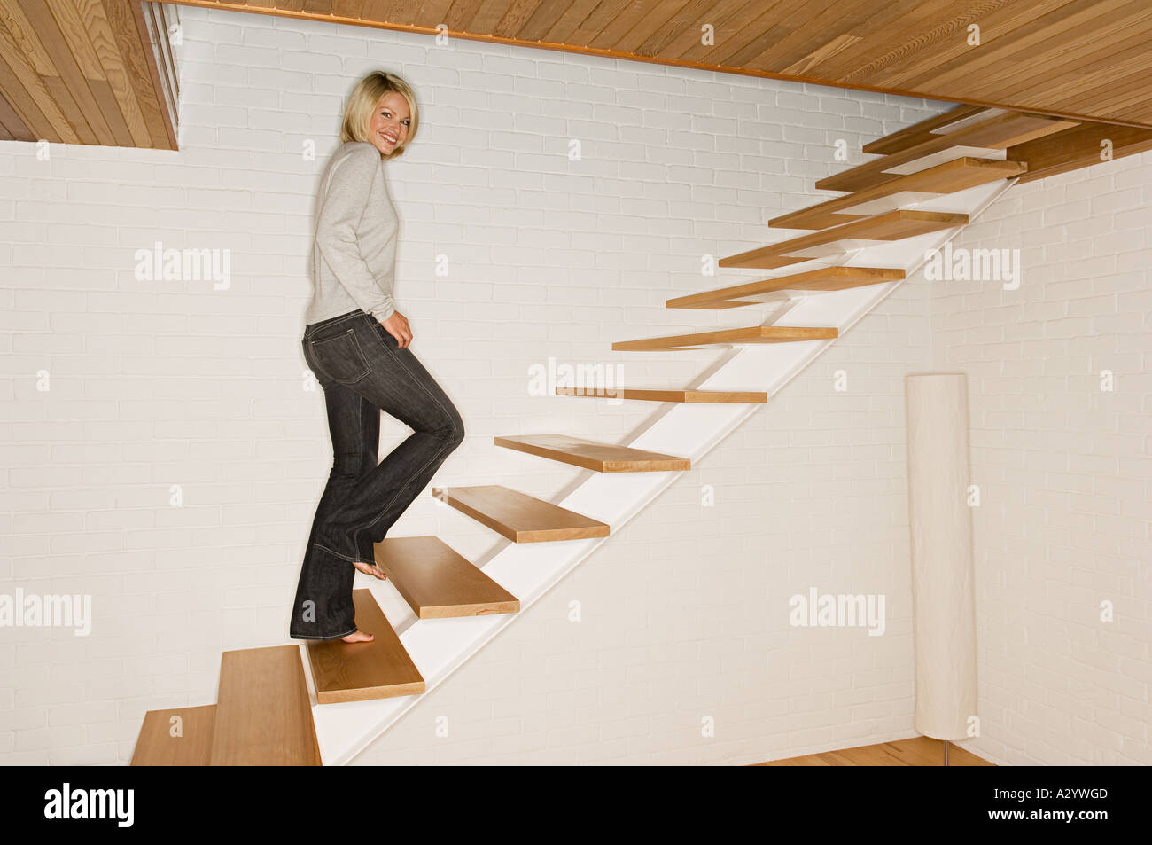 Adult woman stands on stairs hi-res stock photography and images - Alamy
