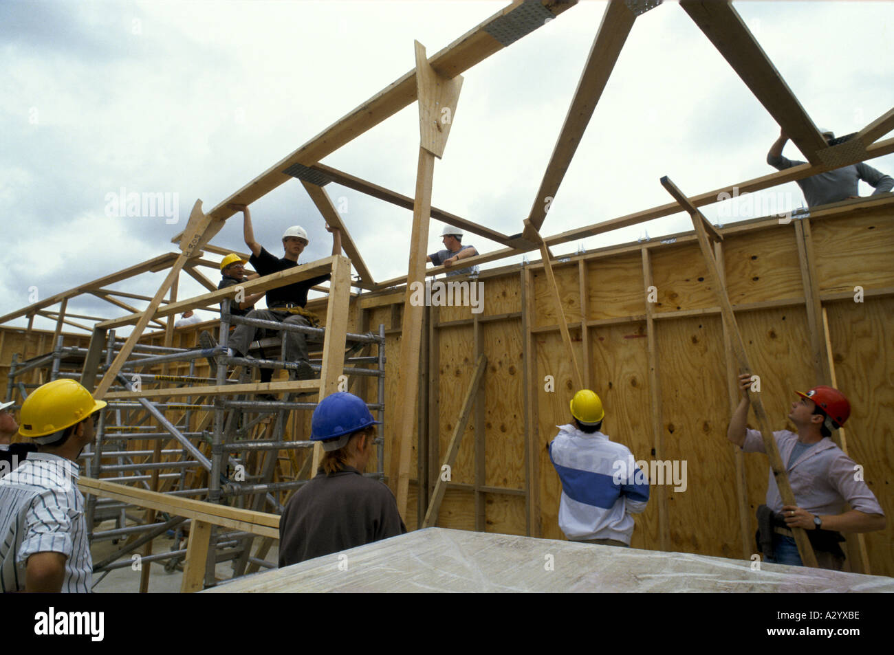 construction workers erecting timber structure in building site 1992 ...