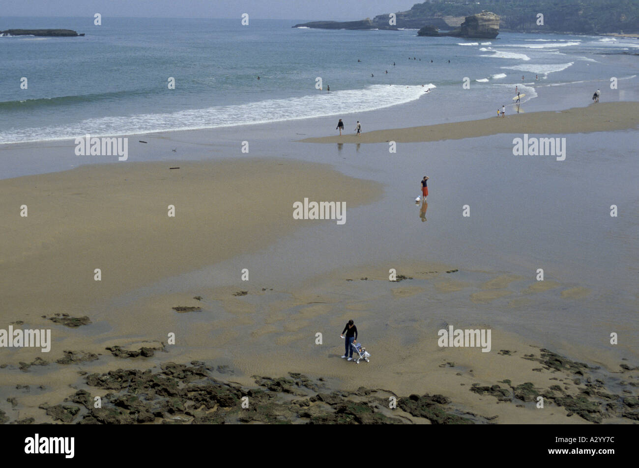 Holiday makers and bathers walking on a beach in Biarritz France Stock ...