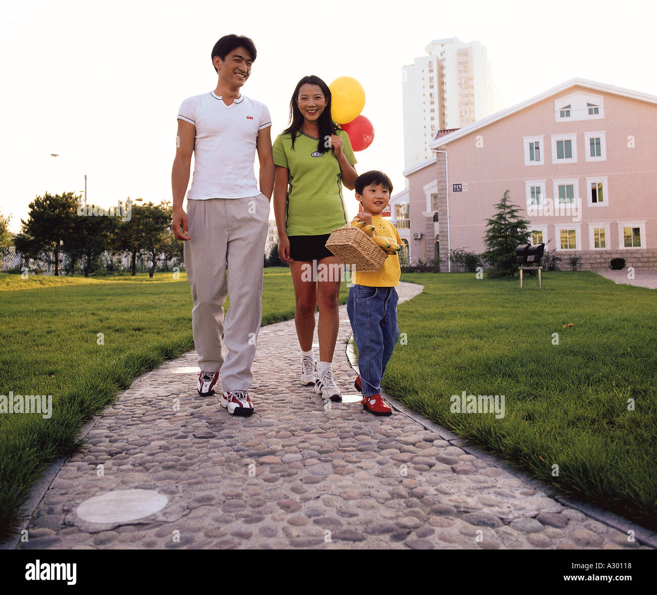 Chinese three people family walking in a village Stock Photo - Alamy