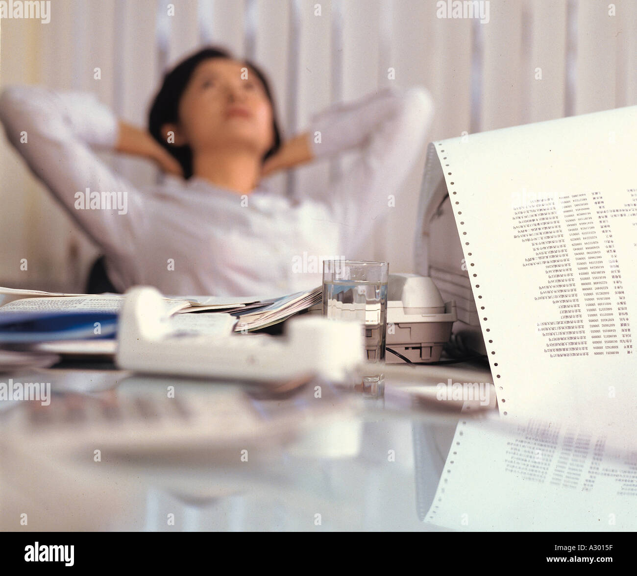 a chinese business woman sitting in a chair and being tired Stock Photo ...
