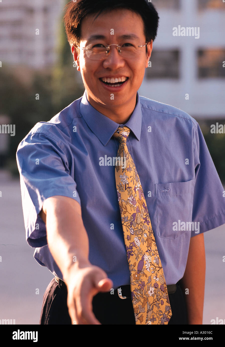 a chinese business man make a gesture of handshake Stock Photo - Alamy