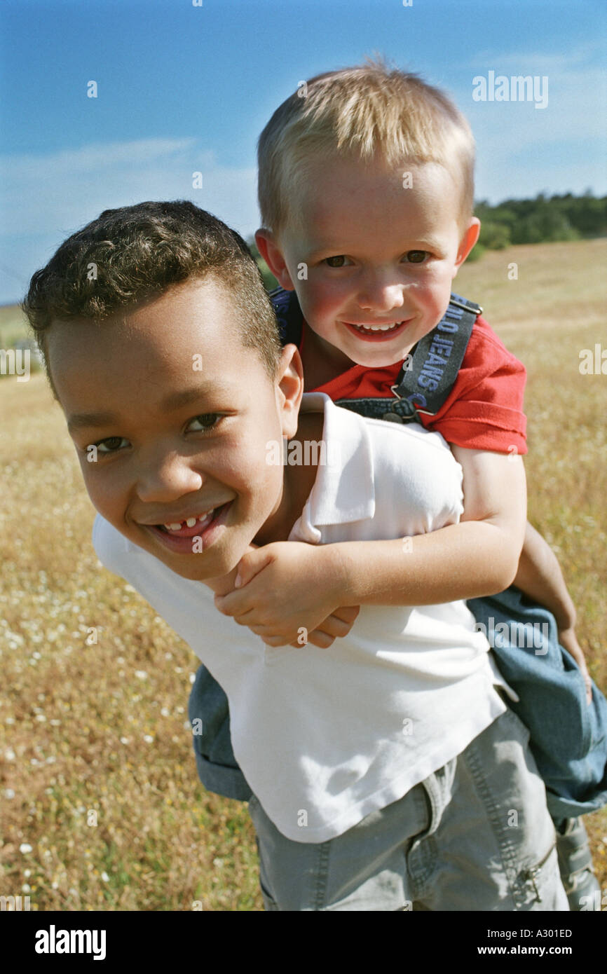 2 boys playing piggyback Stock Photo - Alamy