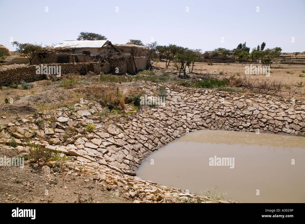 A partially dry man made hole dug to capture and hold water during the ...