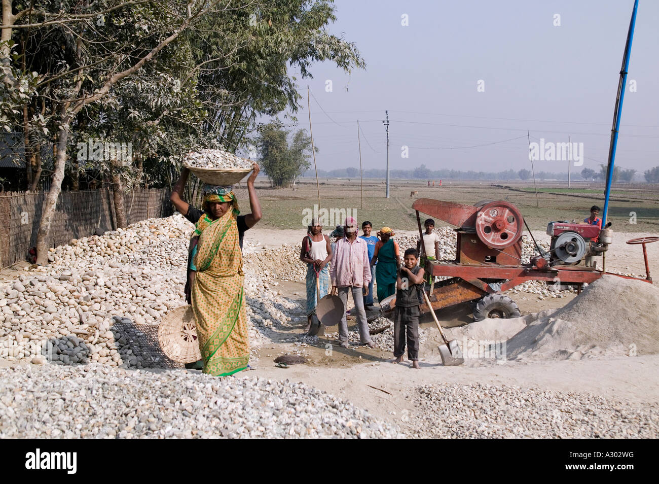 Workers at a rock breaking site moving rocks in Northern Bangladesh ...