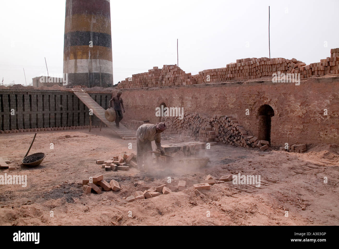 Picking up bricks at a brick making factory in Bangladesh Stock Photo ...