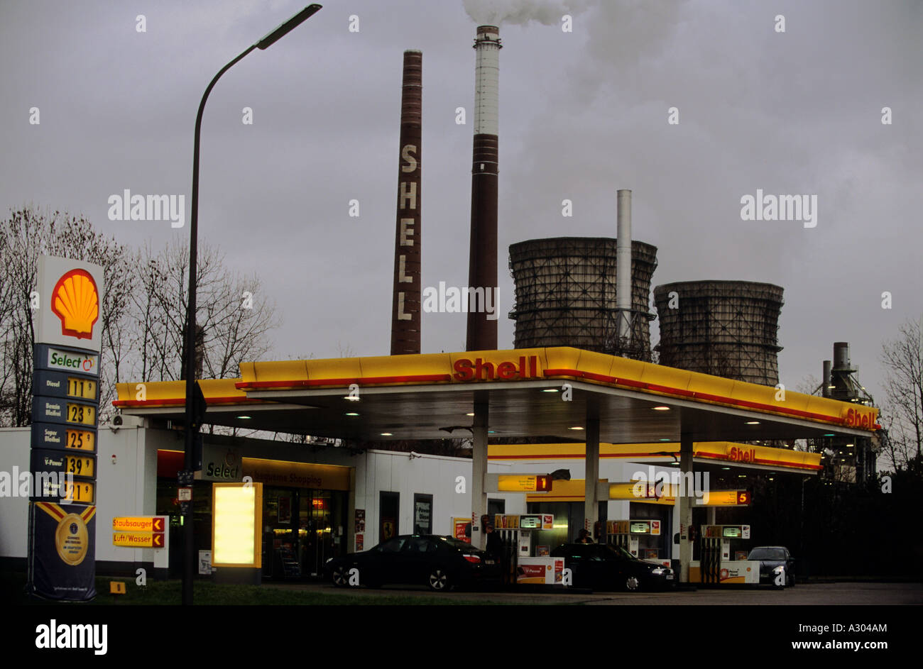 Shell petrol station and oil refinery Stock Photo - Alamy