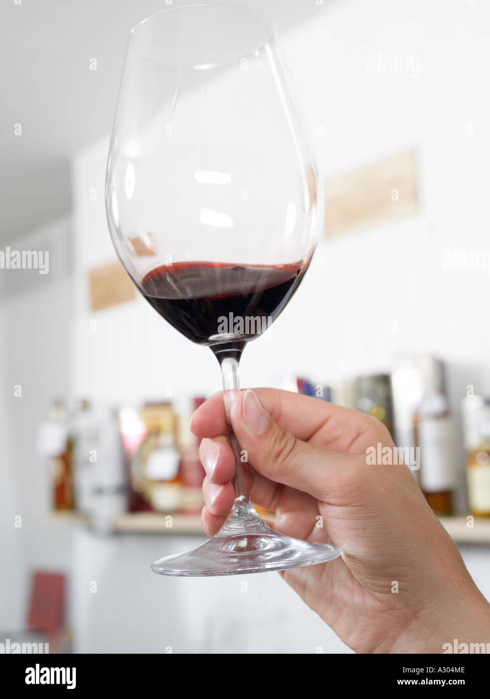 Hand holding wine glass Stock Photo - Alamy