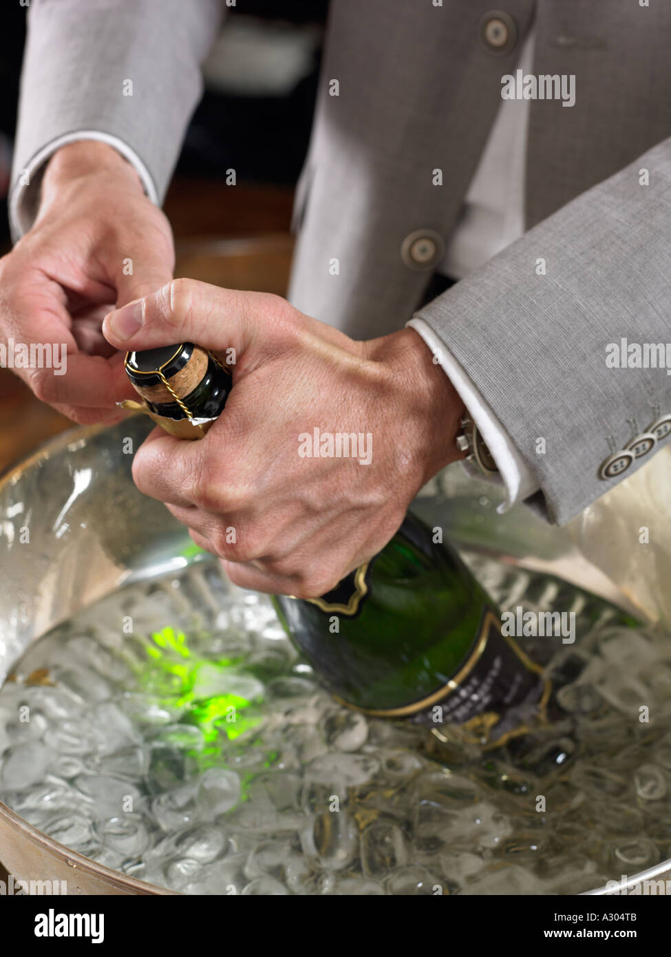 Man opening champagne bottle Stock Photo - Alamy