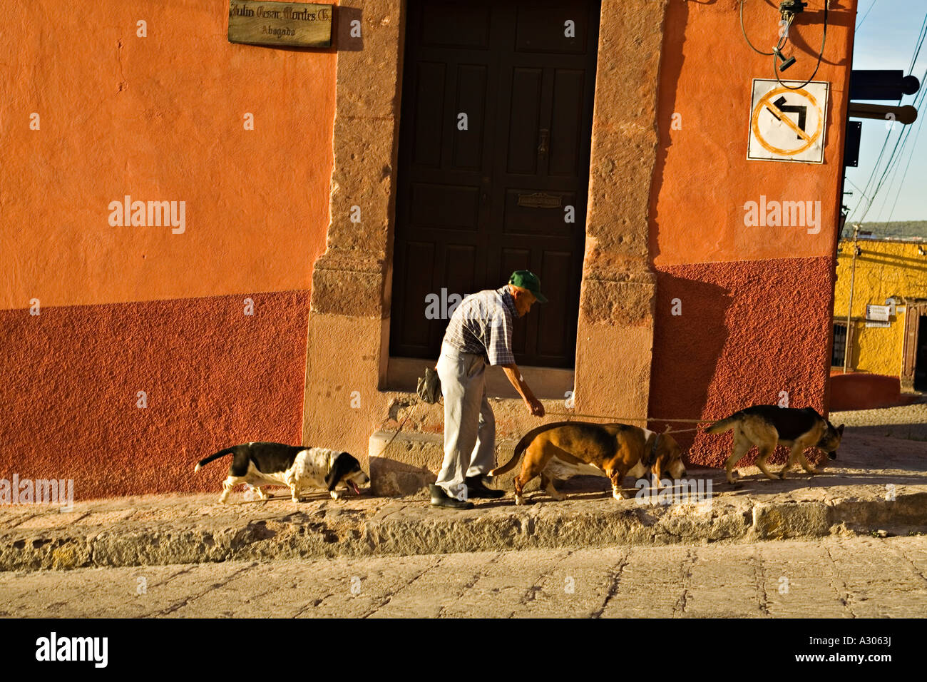 MEXICO San Miguel de Allende Older man walk slumped over with three ...