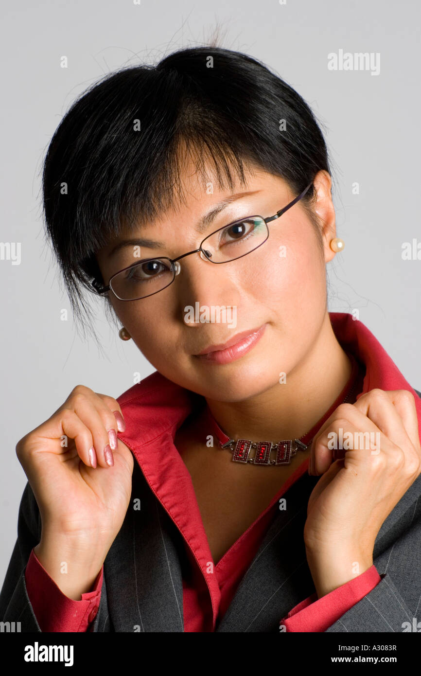 Chinese business woman in business suit and spectacles Stock Photo - Alamy