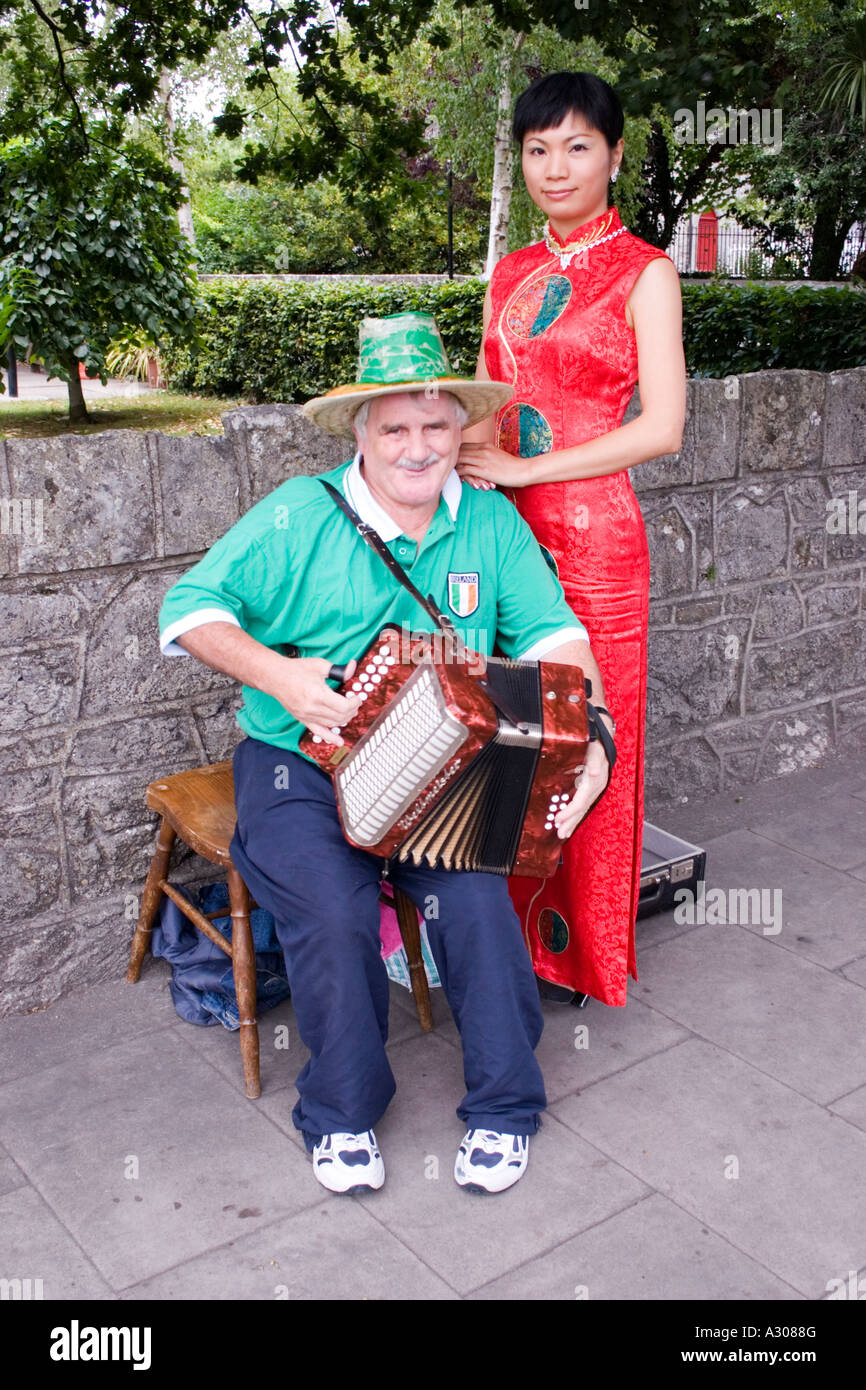 Chinese woman in traditional dress with a musician Stock Photo - Alamy