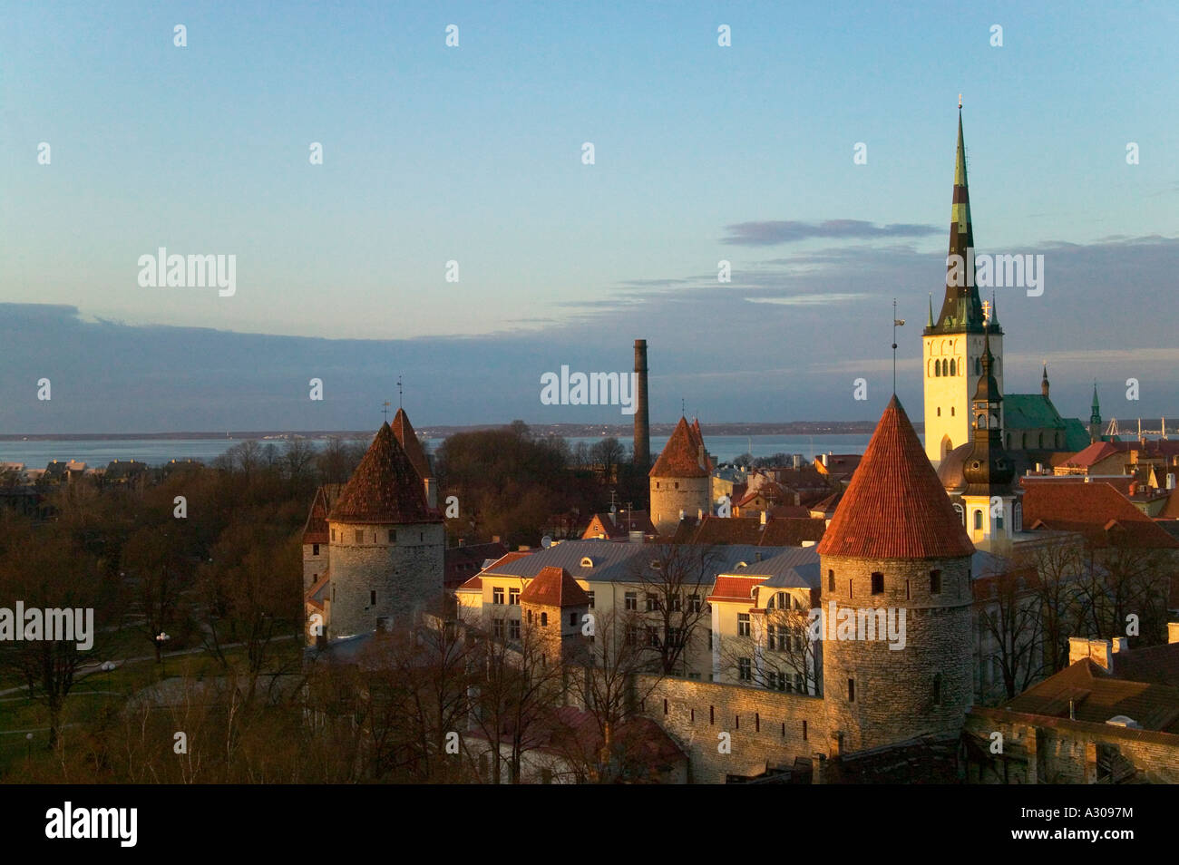 Tallinn cityscape dominated by St Olaf's Church and city wall towers ...