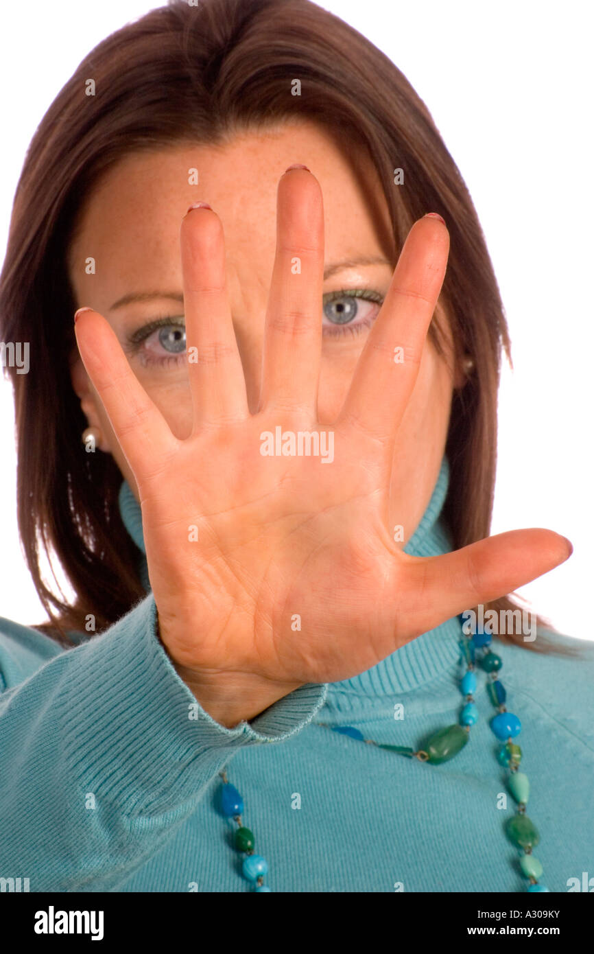 Front view of woman making hand gesture with hand in front of face ...