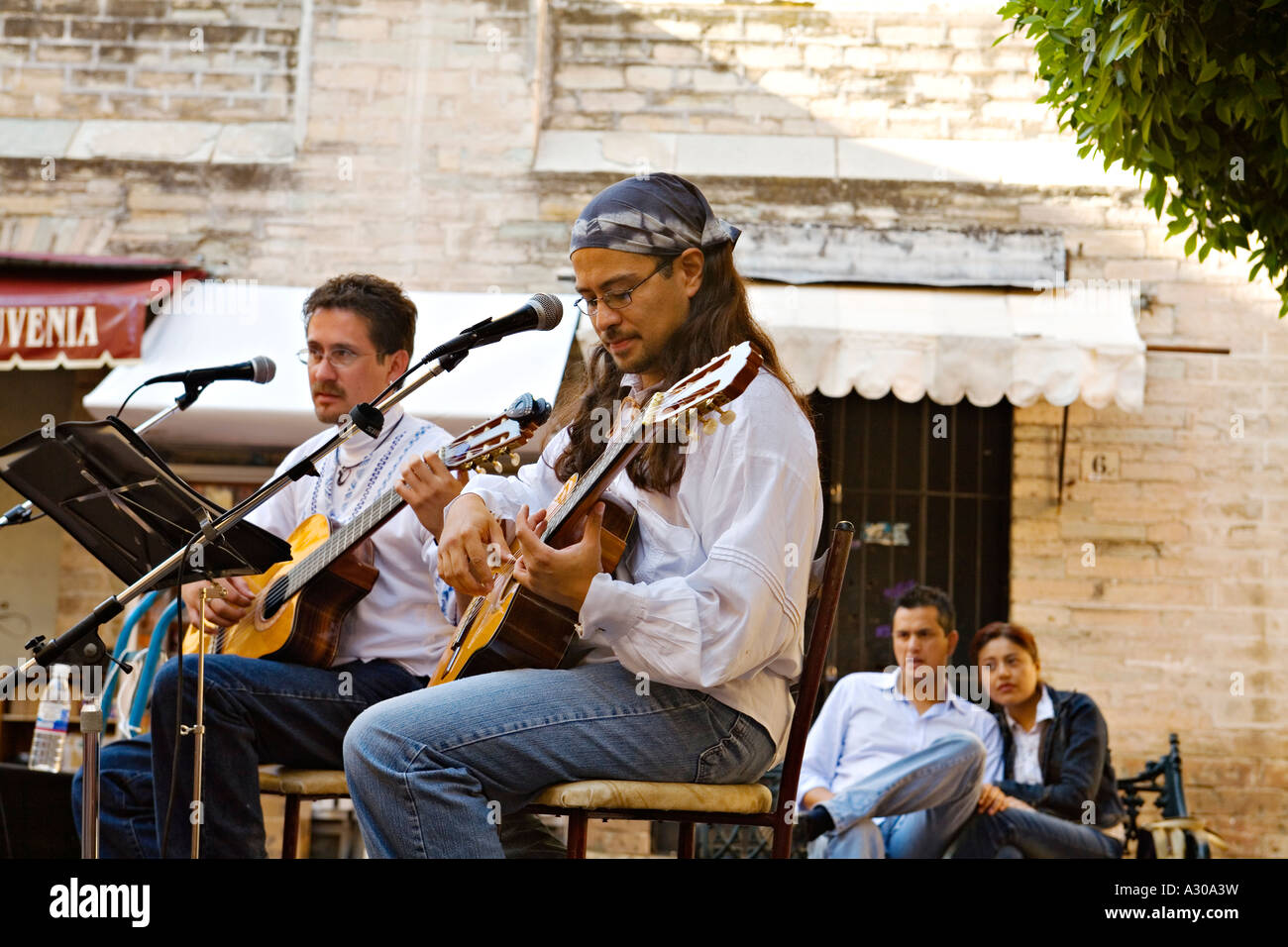 MEXICO Guanajuato Two male musicians play acoustic guitar outdoors ...