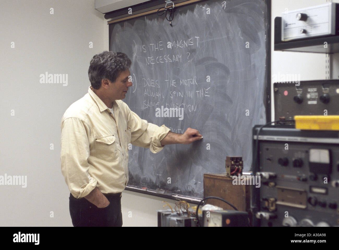 Science teacher writing on blackboard Stock Photo - Alamy