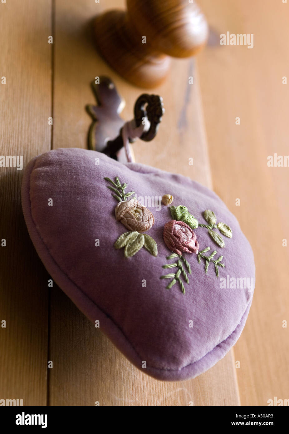 Embroidered lavender key fob and key in antique wooden door Stock Photo ...