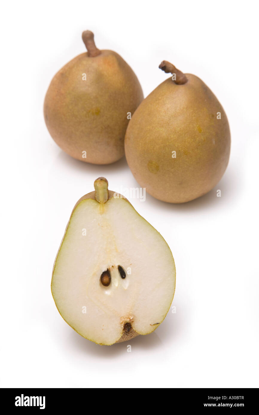 French pears whole and halved isolated on a white studio background ...