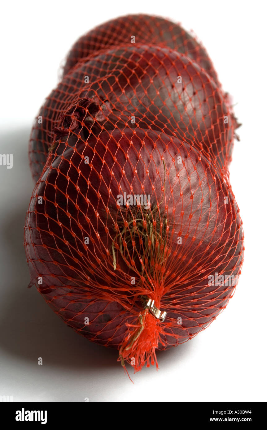 Red Onions in mesh bags against white studio background Stock Photo - Alamy