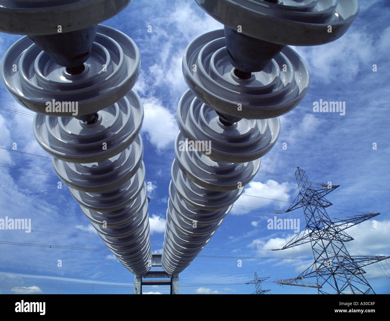 Electricity Insulators on power line on electricity grid Stock Photo ...