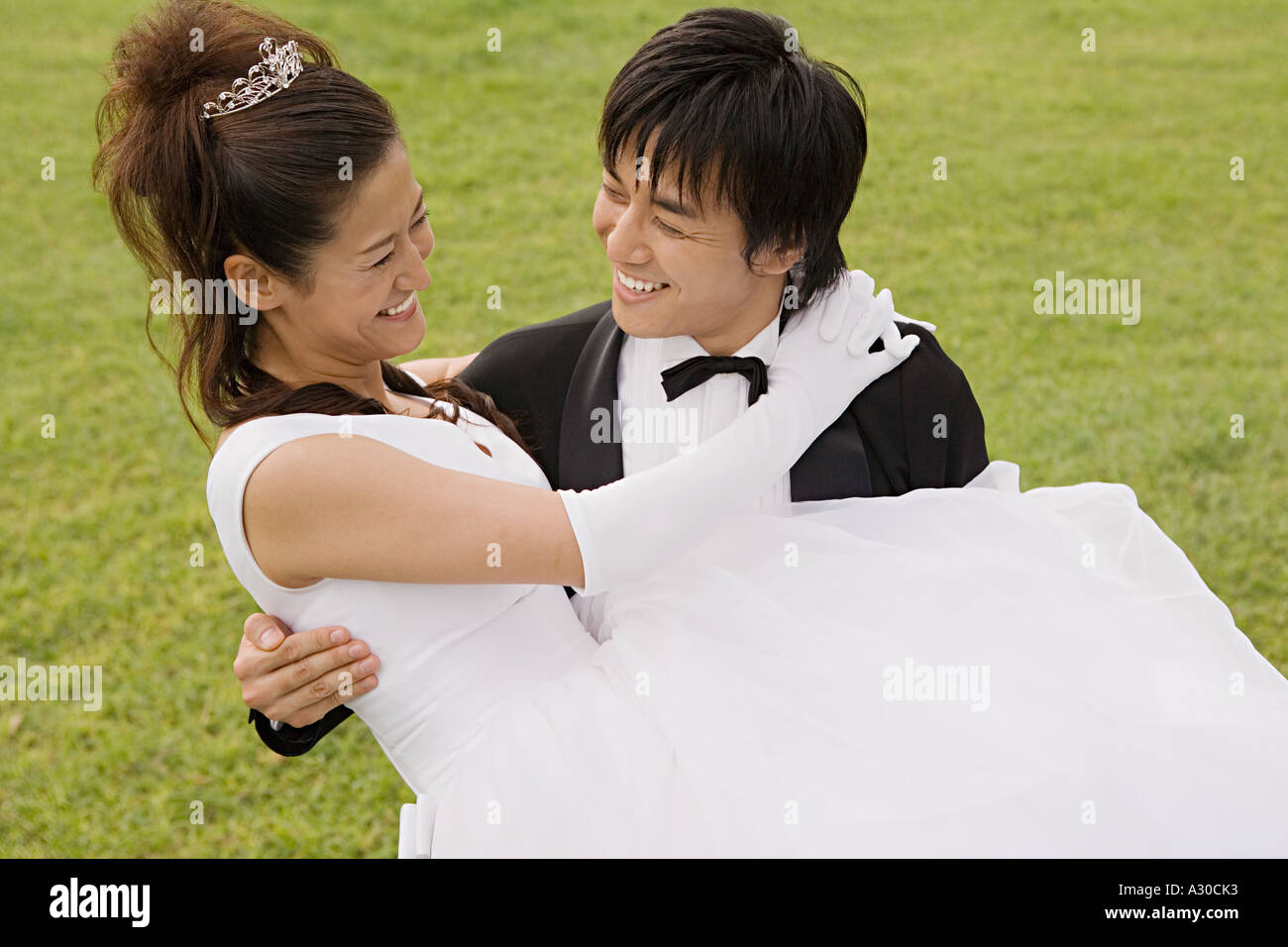 Bridegroom carrying bride hi-res stock photography and images - Alamy